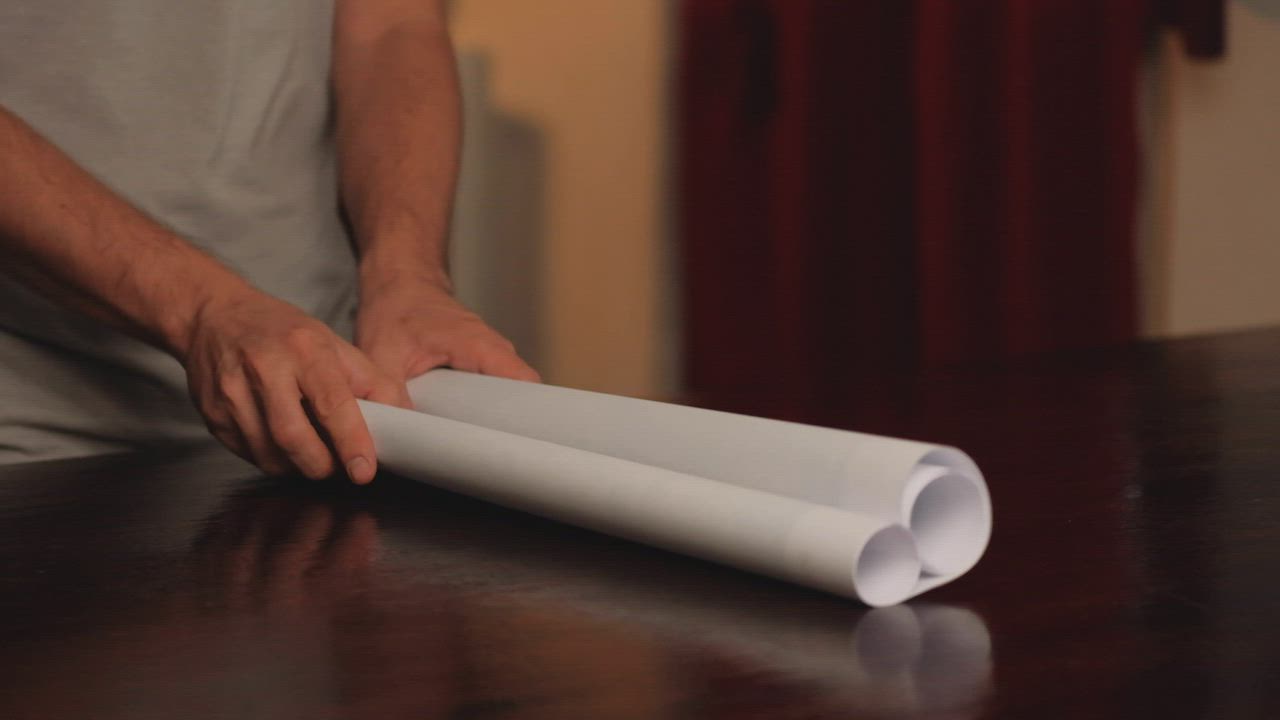 Unrolling a world map on a table - Free Stock Video