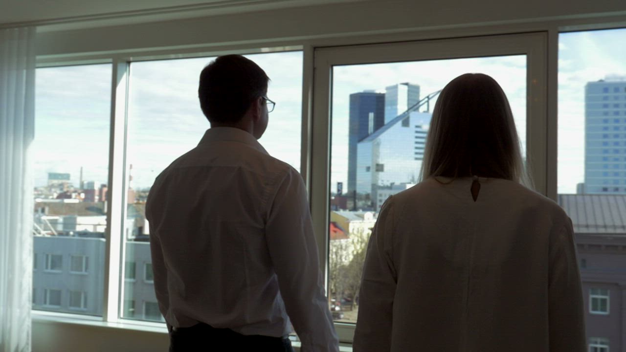 Colleagues looking out of a window - Free Stock Video