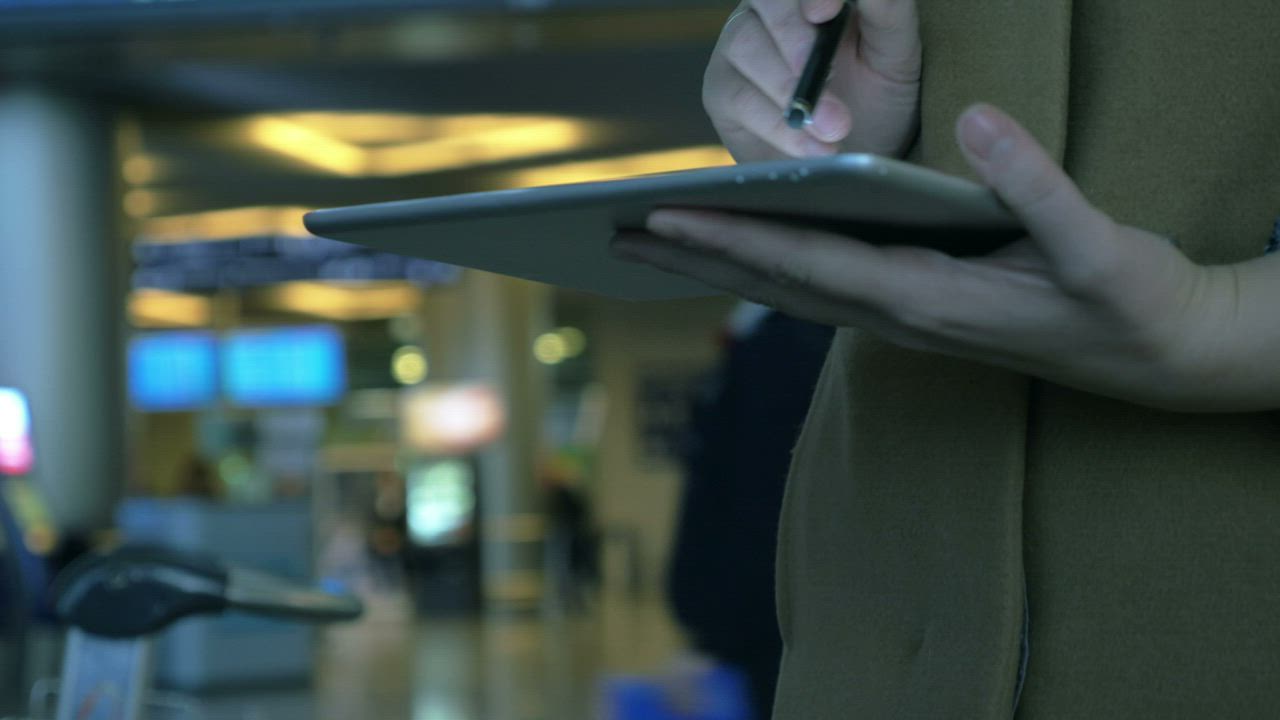 Using a tablet at an airport - Free Stock Video