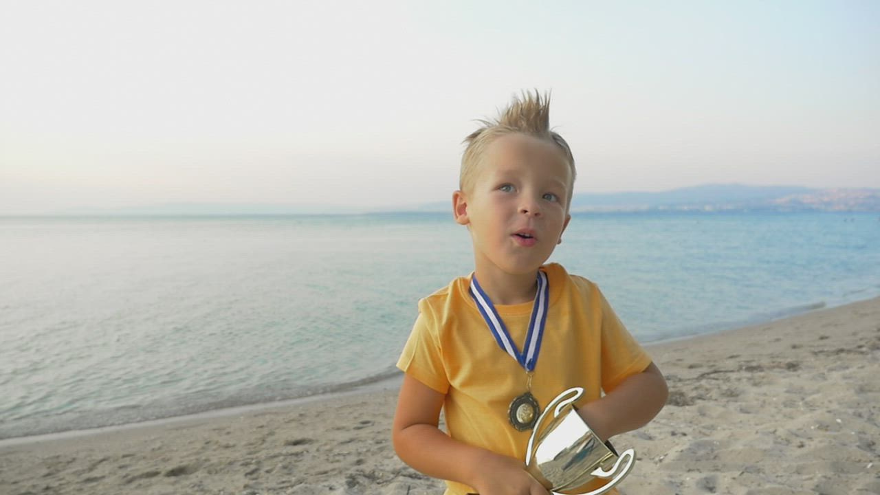 Boy celebrating with his trophy - Free Stock Video