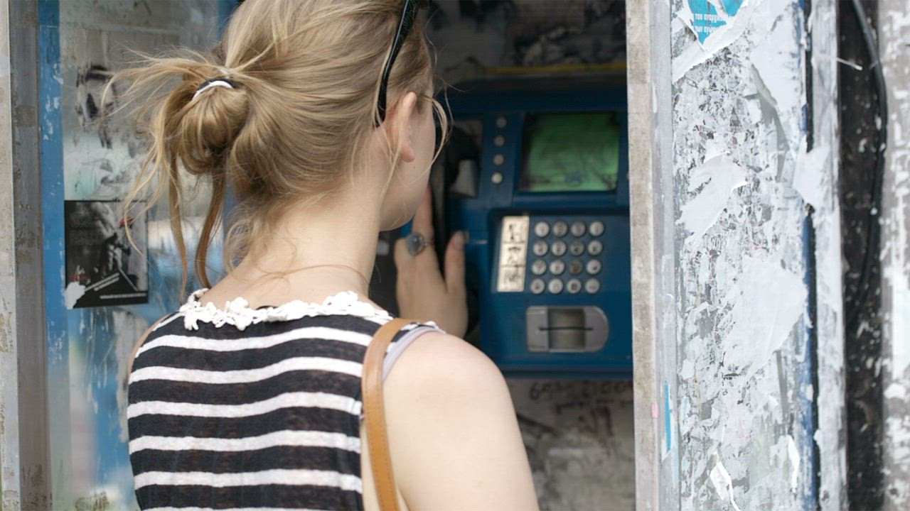 Woman using a public telephone - Free Stock Video