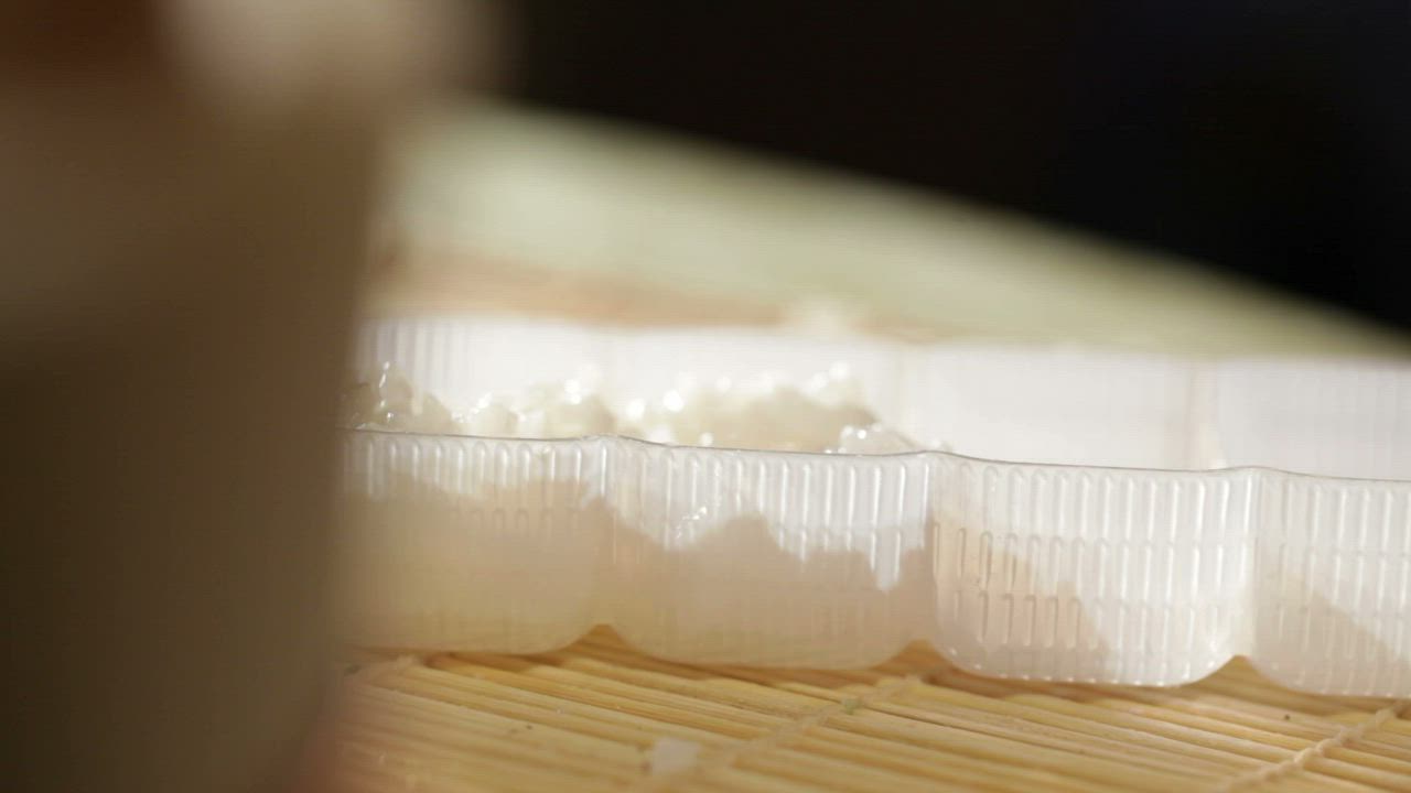 Adding rice to a plastic shape - Free Stock Video