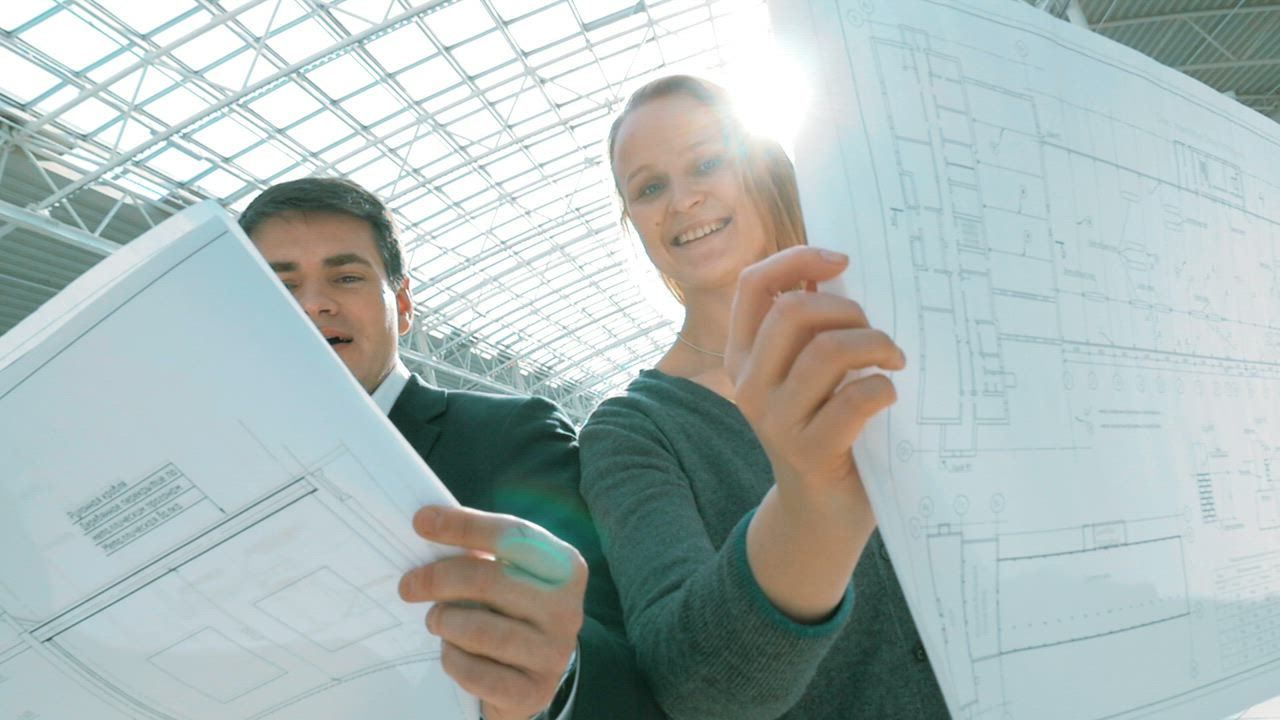 Engineers looking at blueprints - Free Stock Video