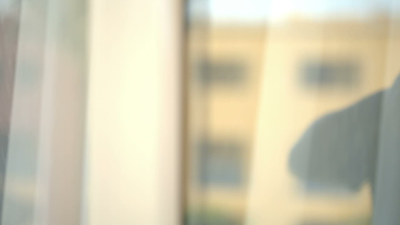 Spraying cleaning fluid on a window - Free Stock Video