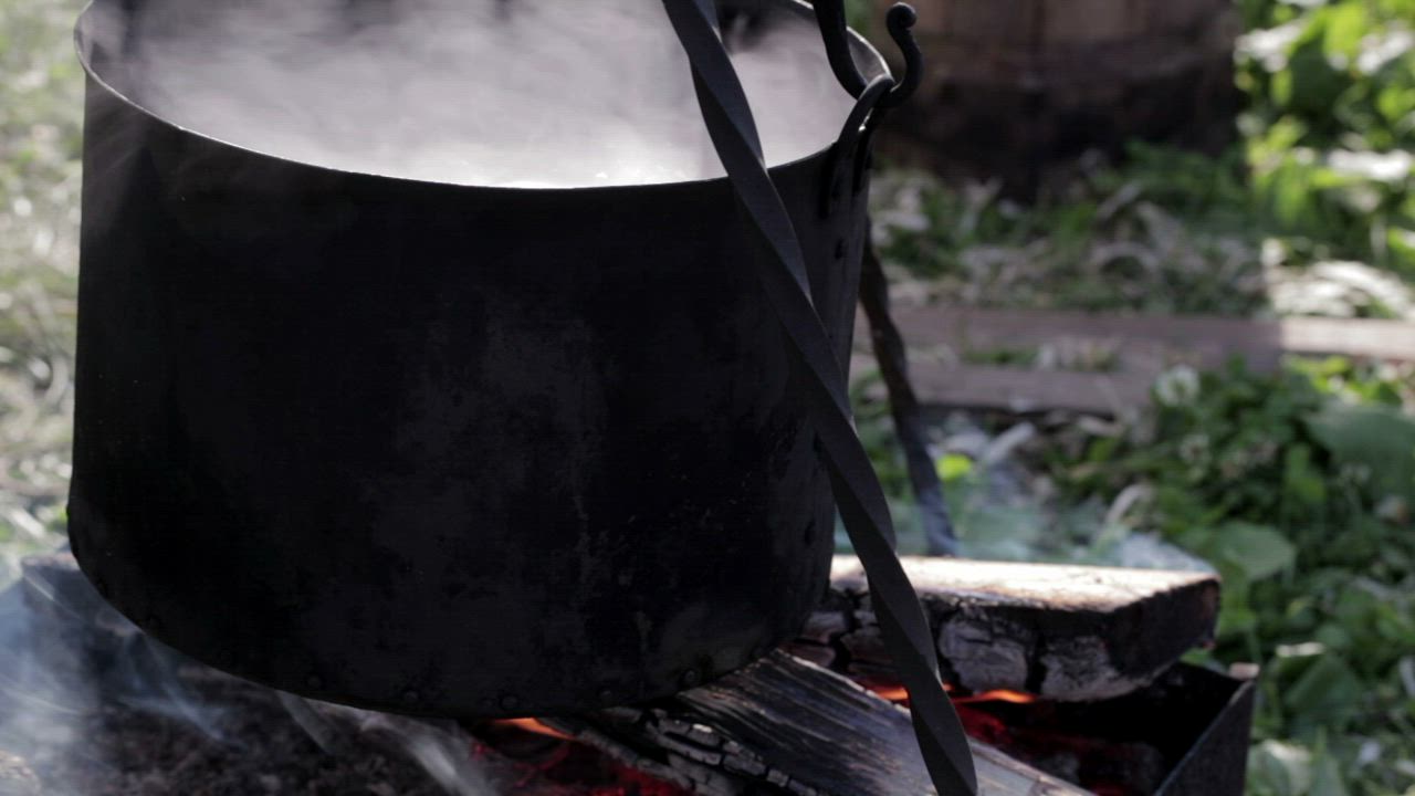 Cooking soup on a campfire - Free Stock Video