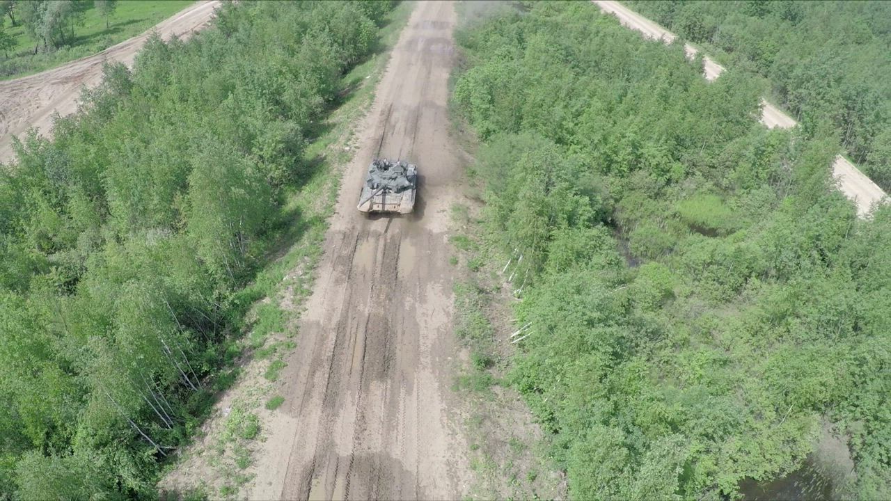 Tank driving over rough terrain - Free Stock Video