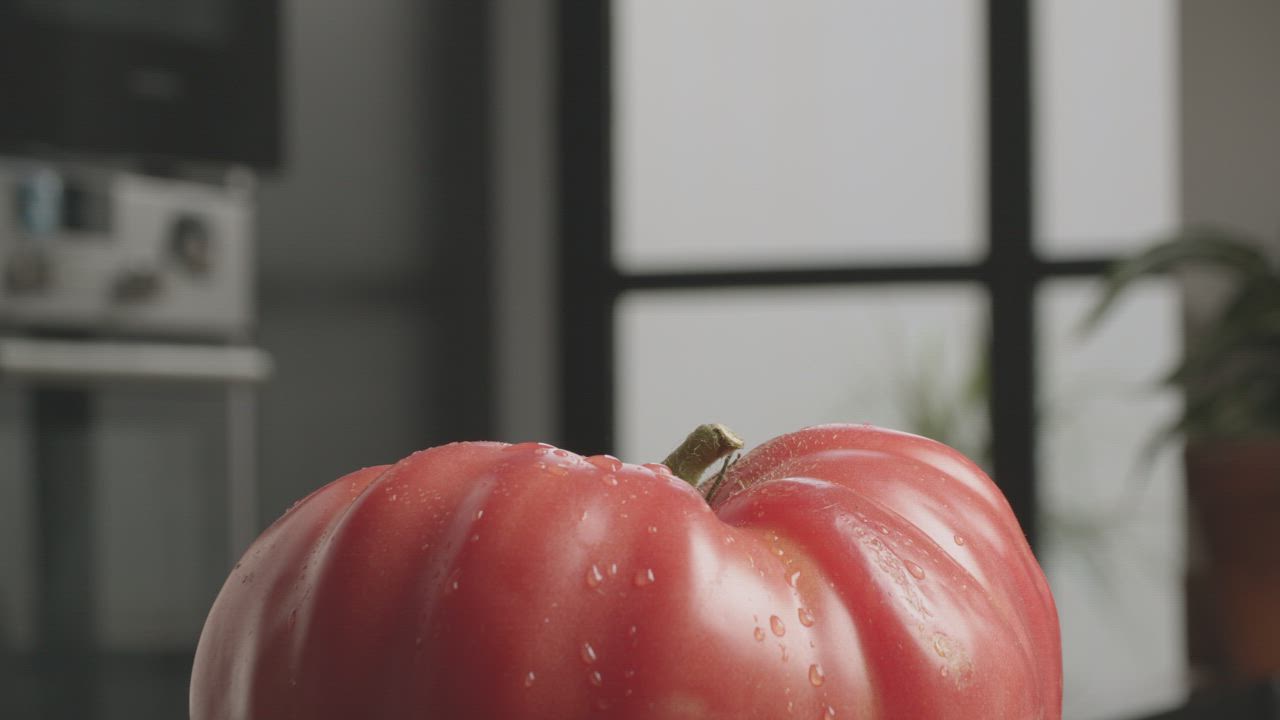 Tomato being prepared in a kitchen - Free Stock Video