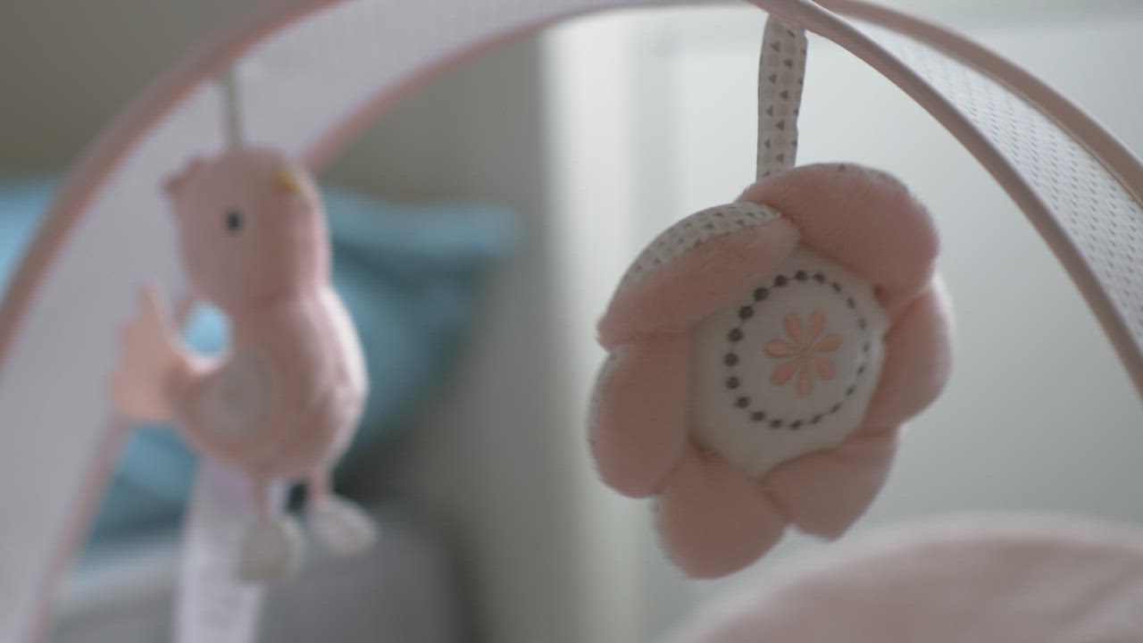 Baby toys hanging over a bed - Free Stock Video