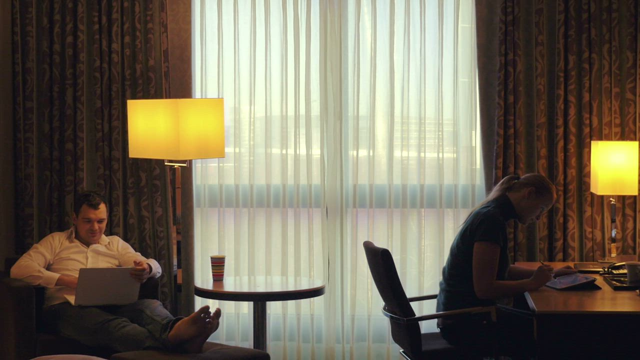 Couple working from a hotel room - Free Stock Video