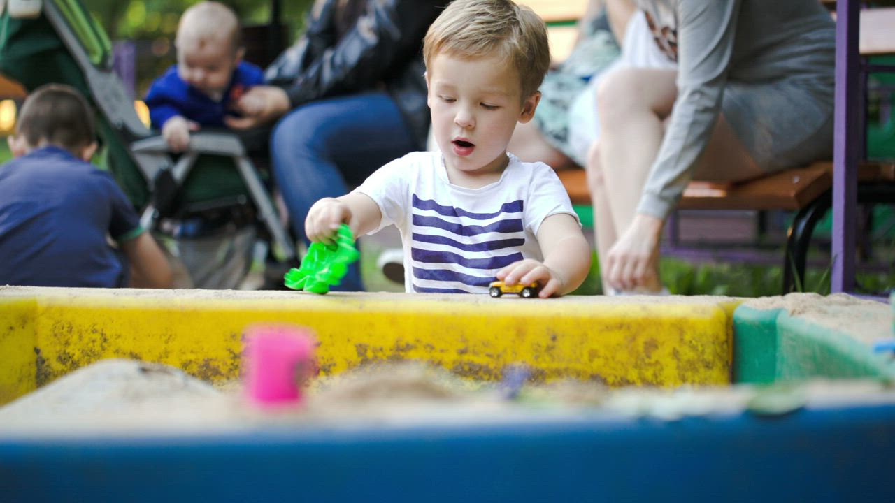 Boy playing in a sand box - Free Stock Video