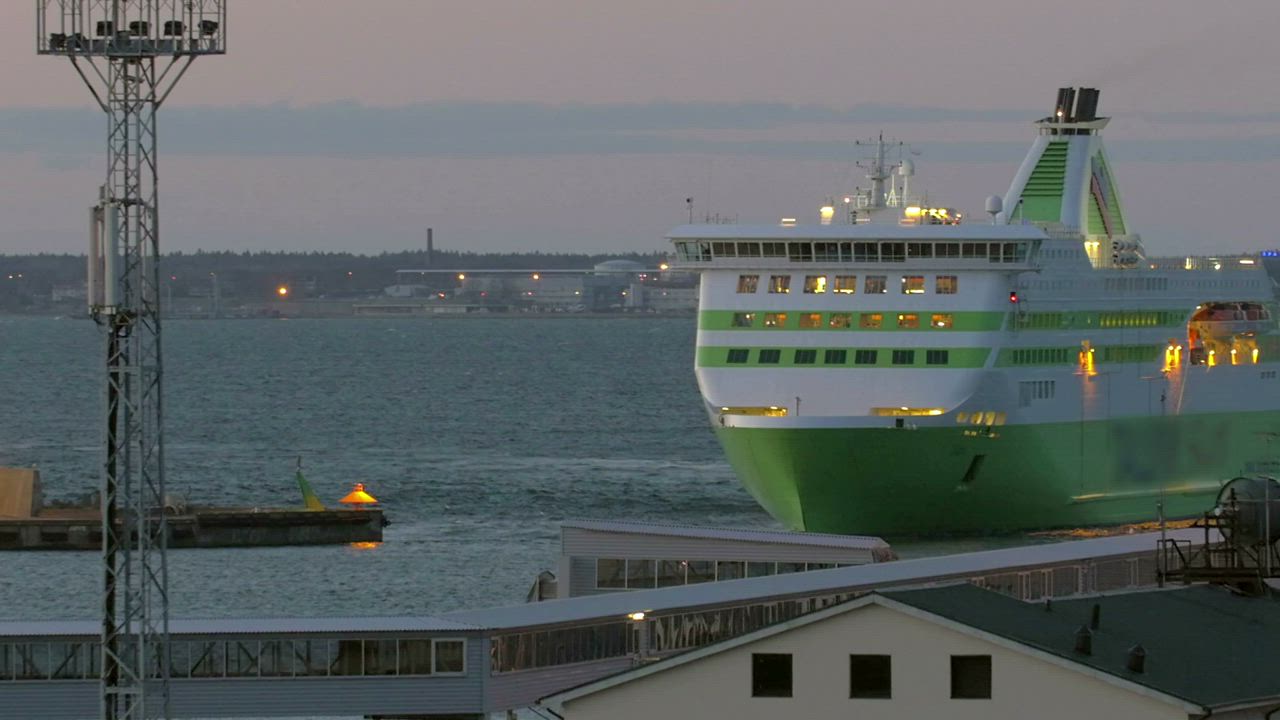 Passenger ship entering port at dusk - Free Stock Video