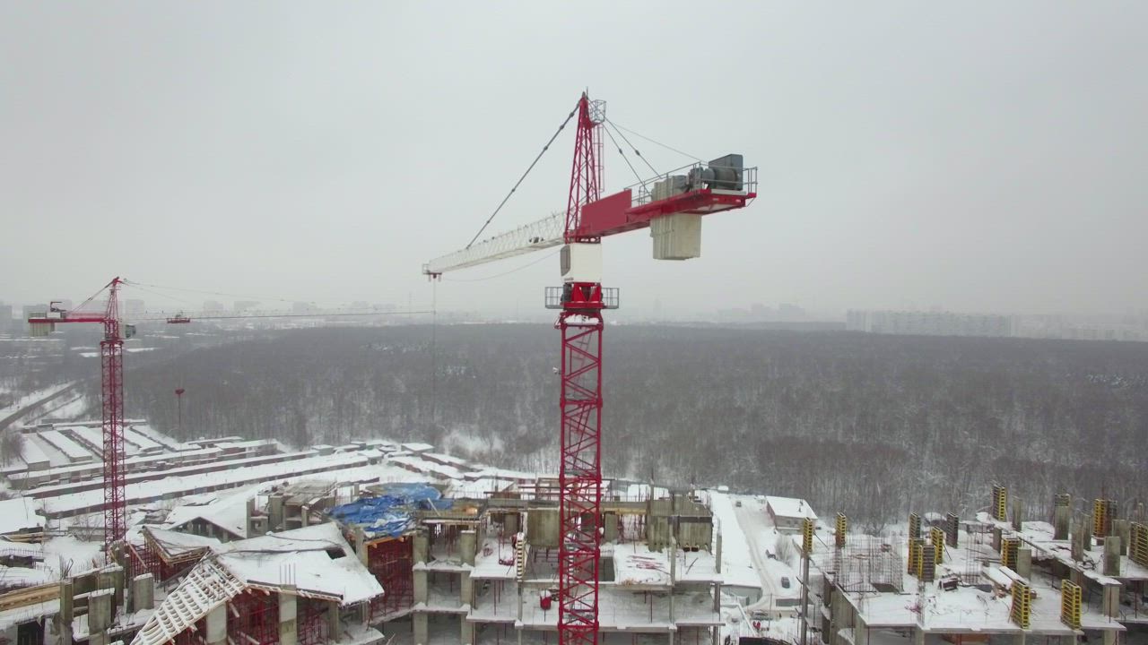 Red crane working in the snow - Free Stock Video