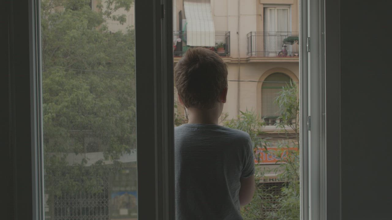 Young boy clapping at a window - Free Stock Video