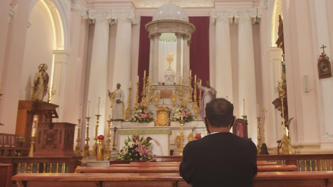 Person praying in front of an altar inside a church - Free Stock Video