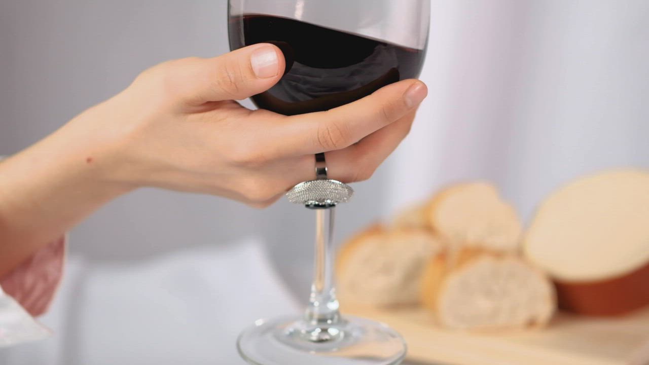 Woman mixing red wine in a glass goblet - Free Stock Video