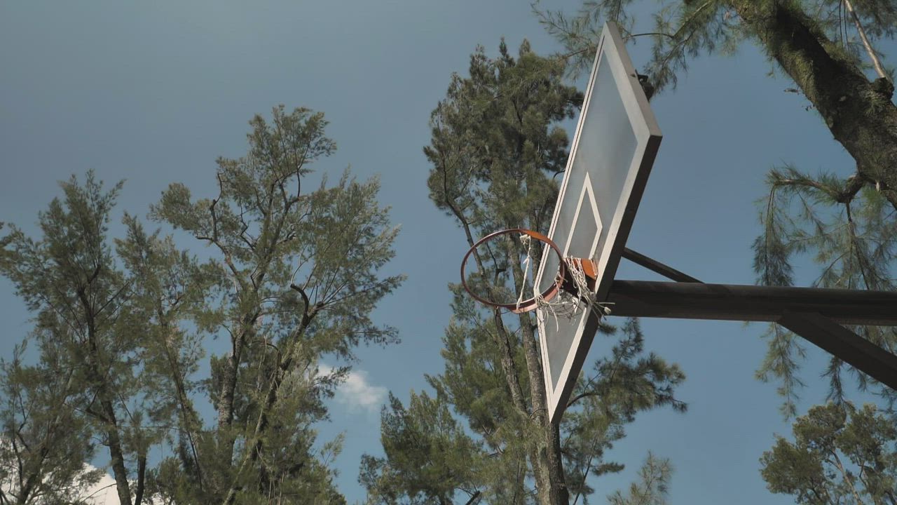 Basketball player hangs on the rim - Free Stock Video