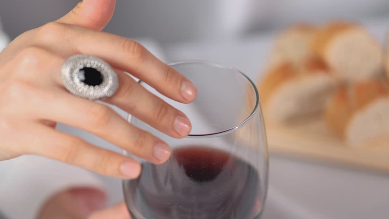 Woman sliding her finger along the edge of a glass - Free Stock Video