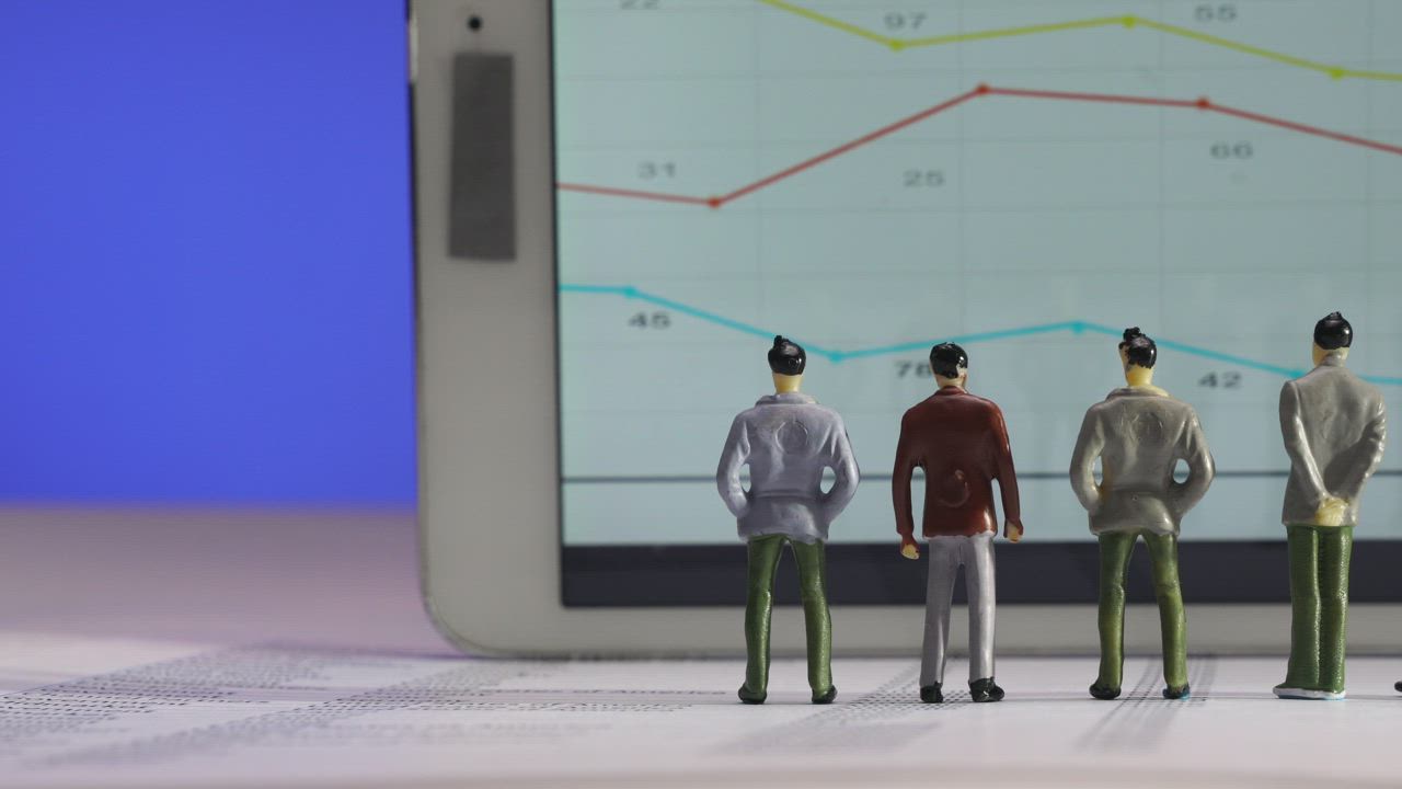 Figures standing by a graph - Free Stock Video
