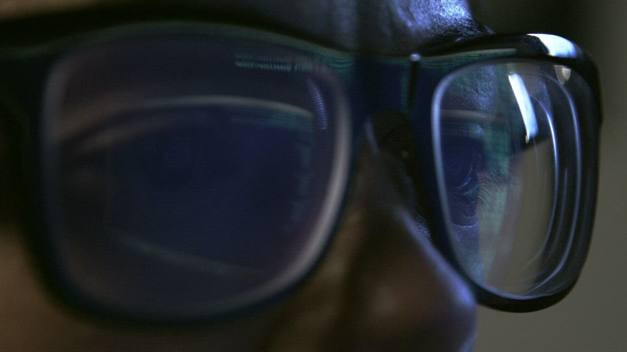 Green code reflecting on glasses - Free Stock Video