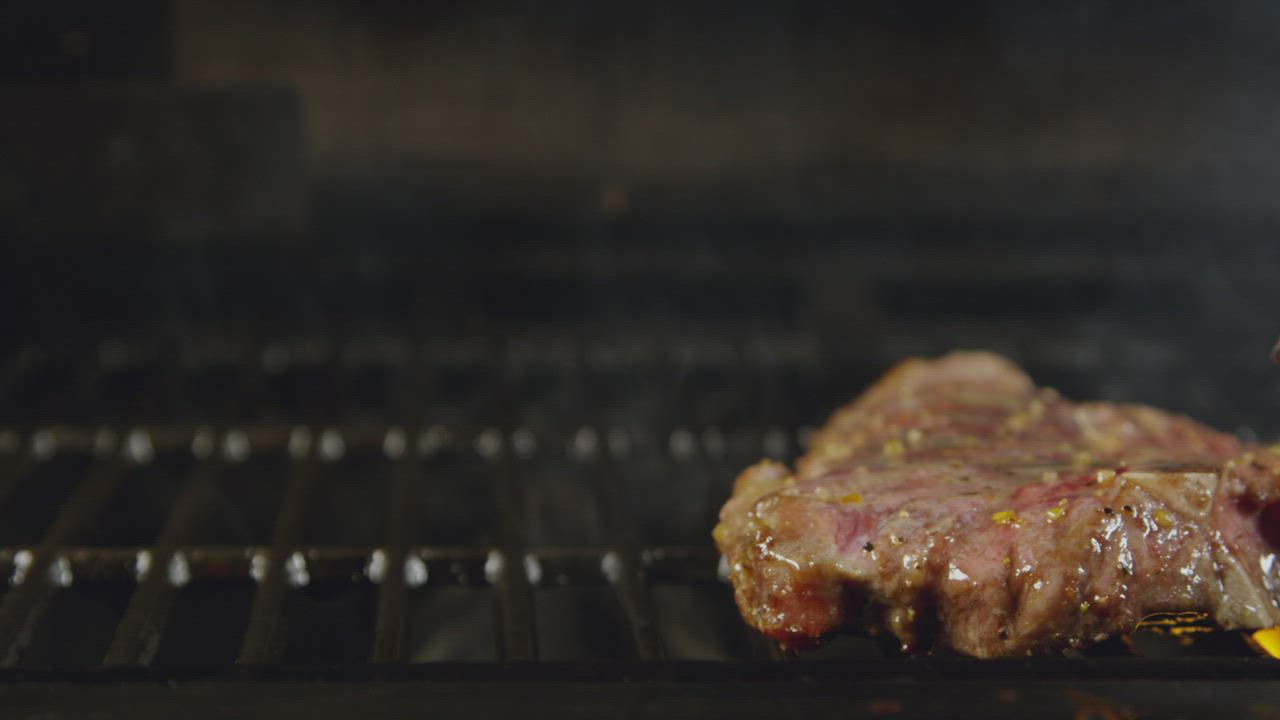 Steak cooking over flames - Free Stock Video