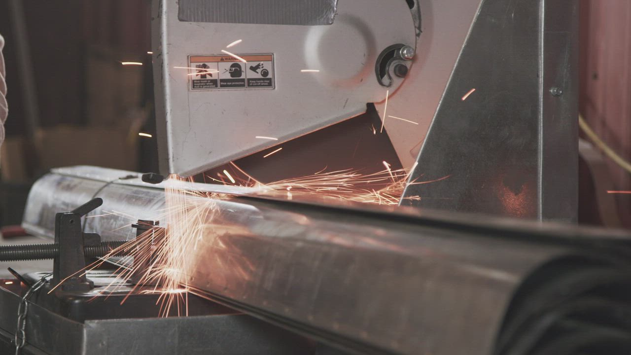 Industrial saw cutting through metal - Free Stock Video