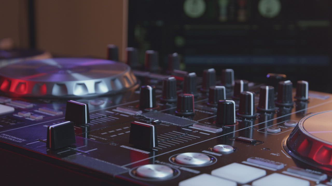 DJ using a mixer table at a party - Free Stock Video
