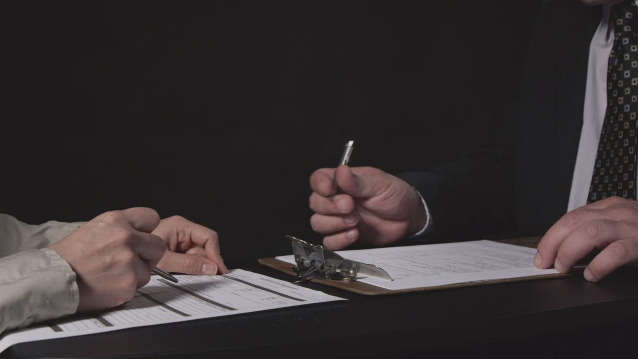 Comparing documents in an interview - Free Stock Video