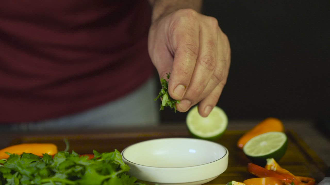 Adding herbs to a bowl - Free Stock Video