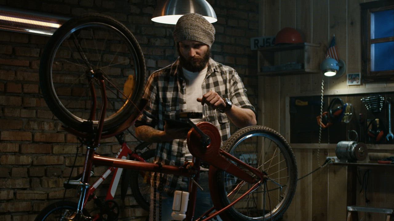 Man watching a tutorial to repair a bike - Free Stock Video