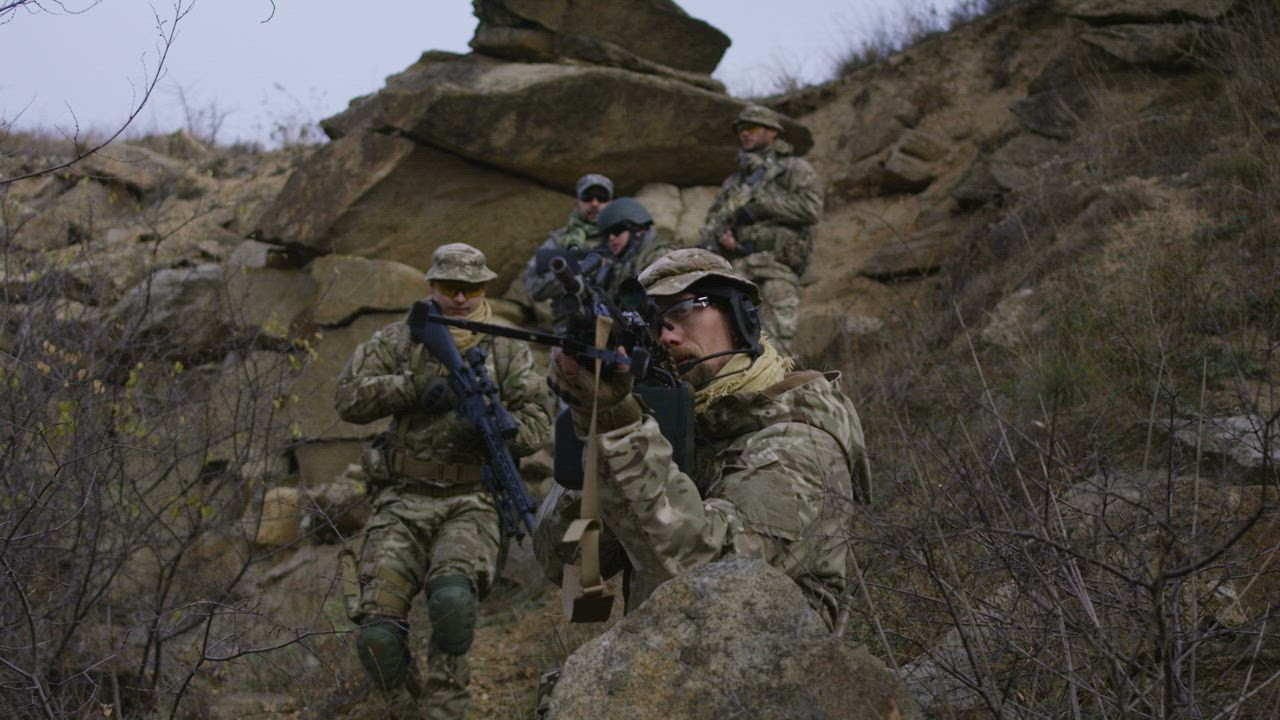 Soldier patrol going down the hill - Free Stock Video