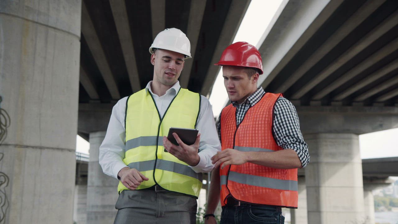 Two workers discussing project outdoors - Free Stock Video
