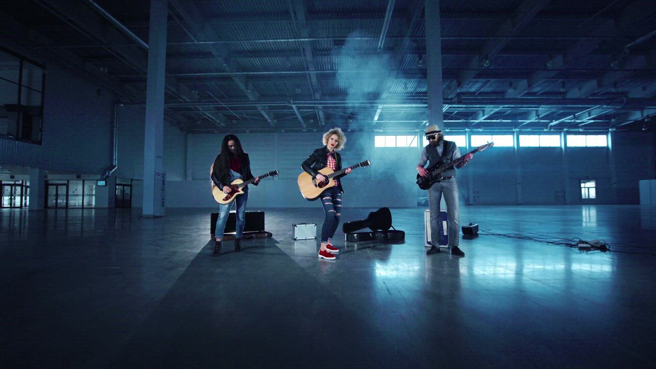 Rock band performing on a warehouse for video - Free Stock Video