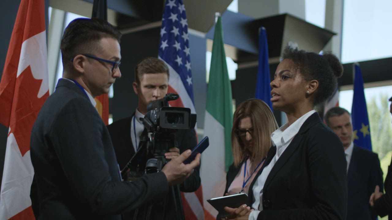 Woman gives an interview at an international summit - Free Stock Video