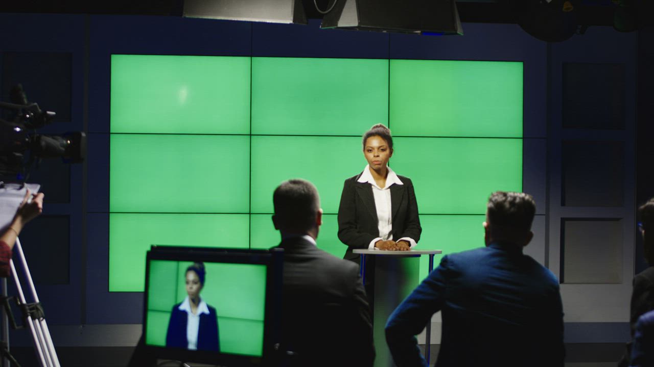 Newsroom presenter in front of green screen background - Free Stock Video