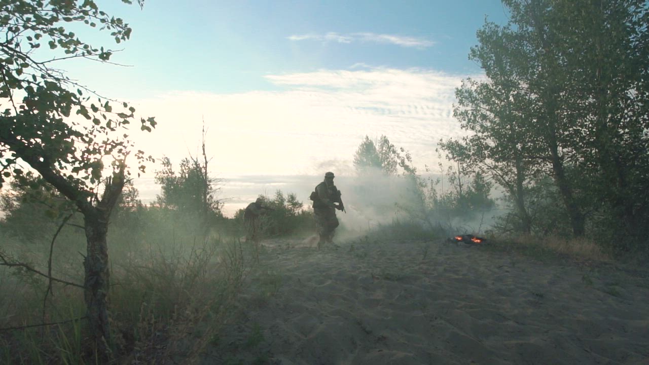 Military men covering ground in the battlefield - Free Stock Video