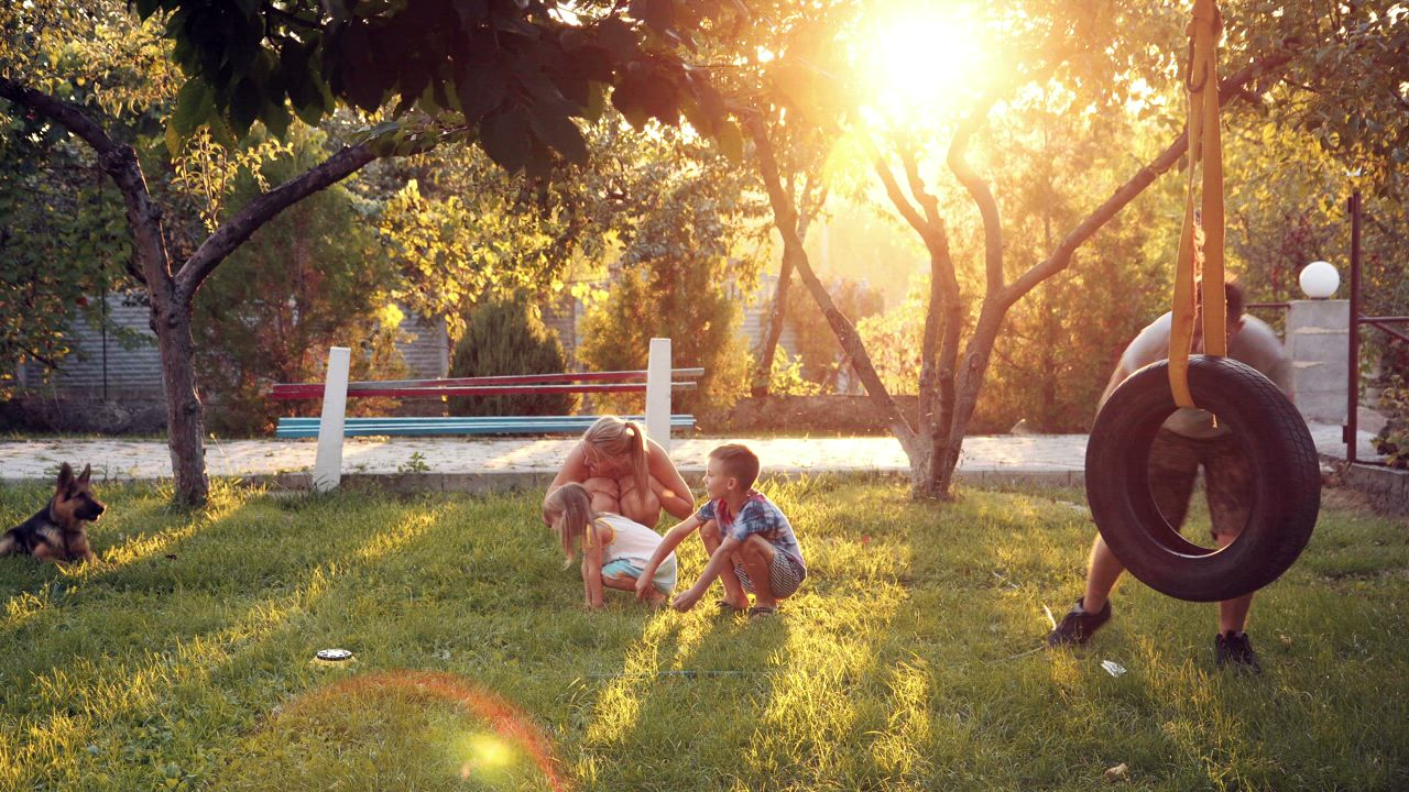 Family playing with a dog in the garden - Free Stock Video