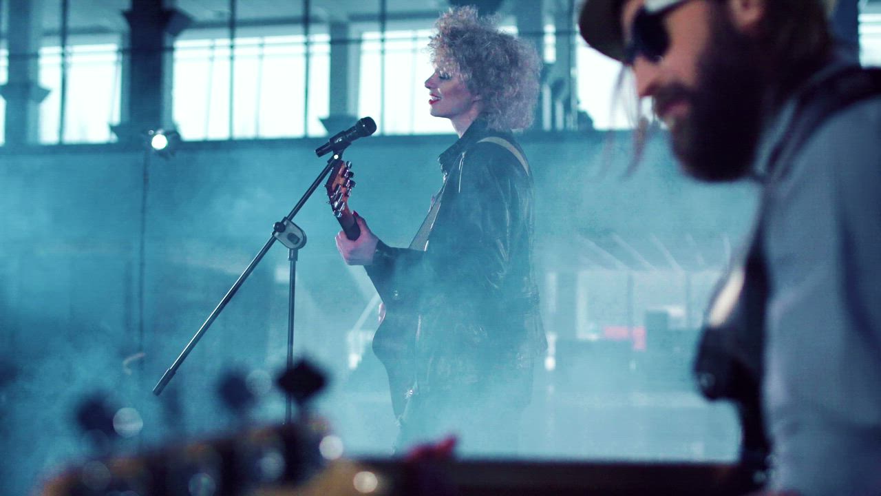 Band recording a video in an empty warehouse - Free Stock Video