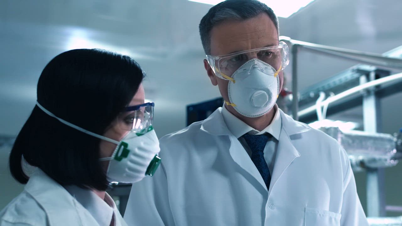 Scientists wearing a face mask talking in the lab - Free Stock Video