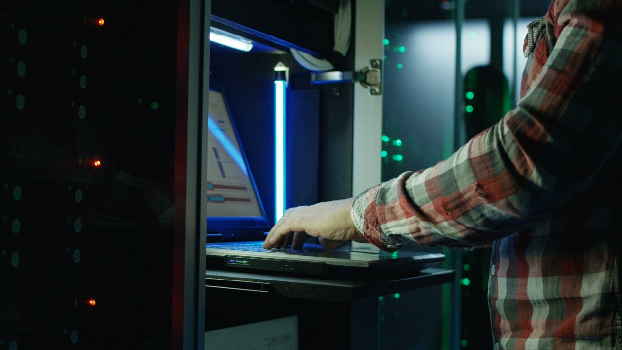 Hands working with laptop in datacenter - Free Stock Video