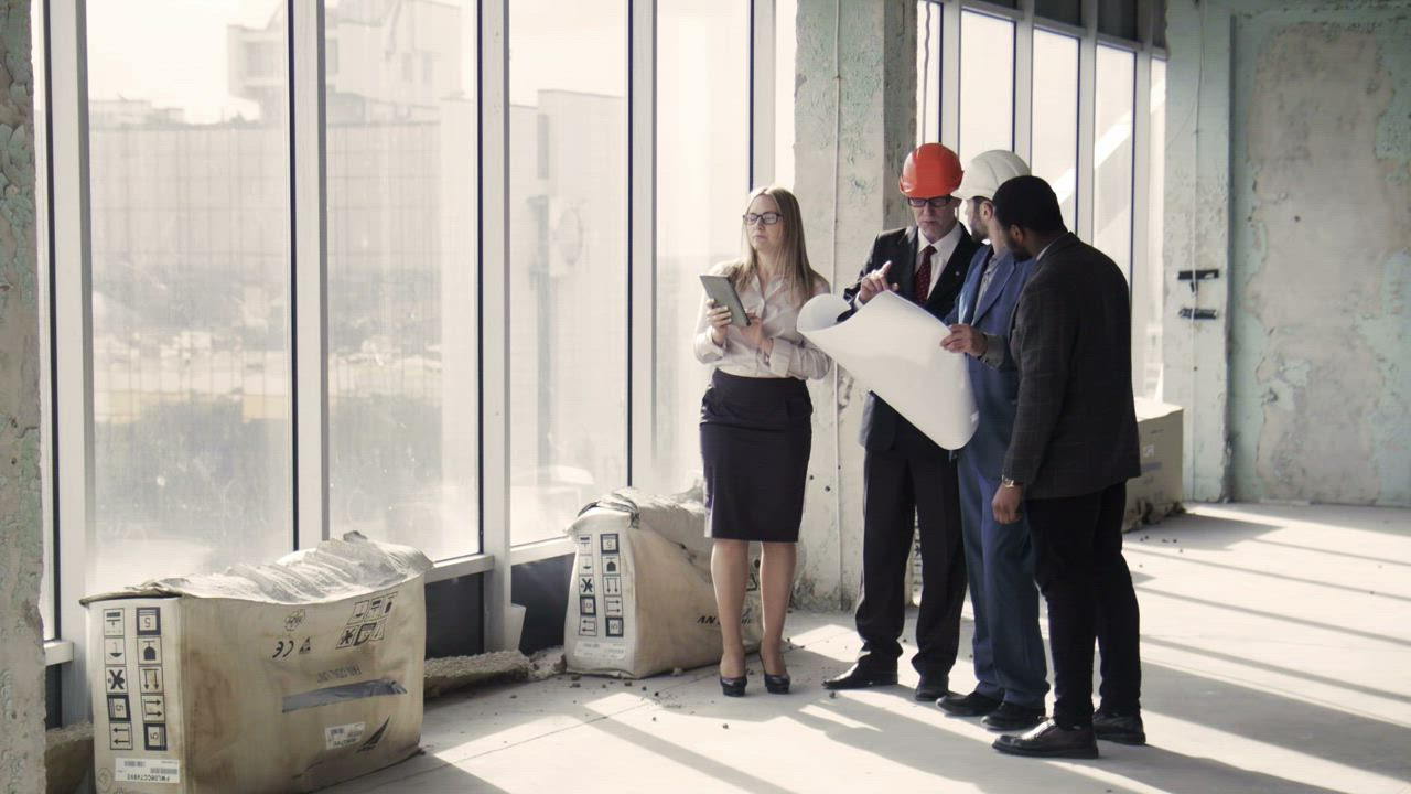 Architects discussing building plan - Free Stock Video