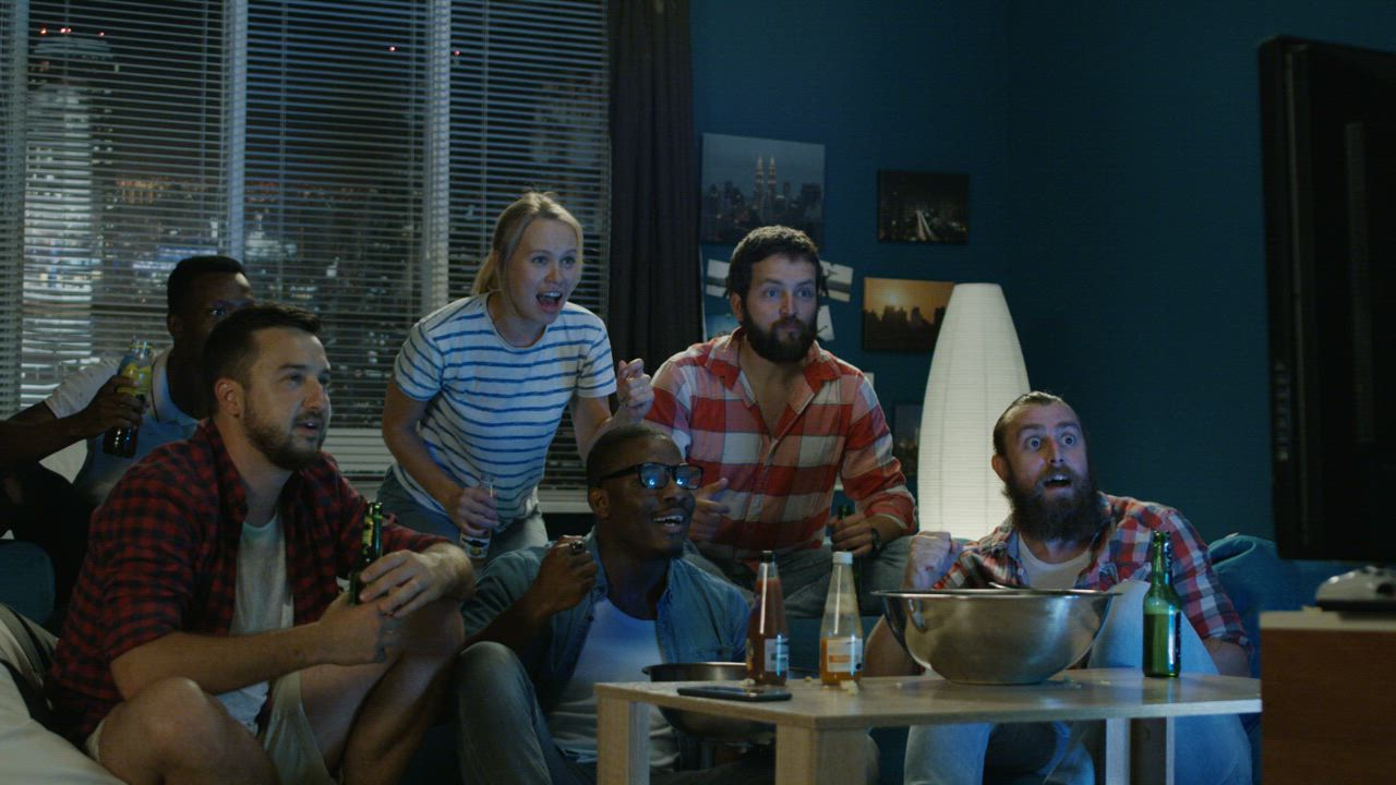 Exciting fans cheering for sports on the TV - Free Stock Video