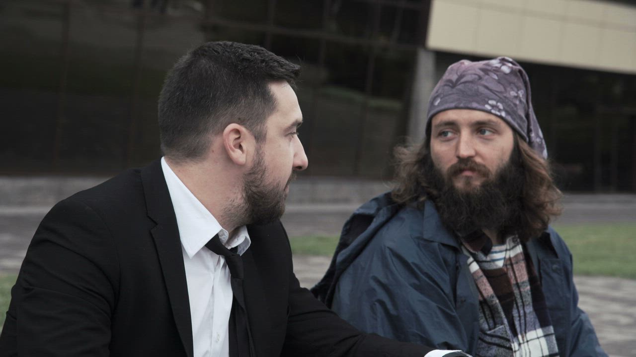 A business man and homeless eating together - Free Stock Video