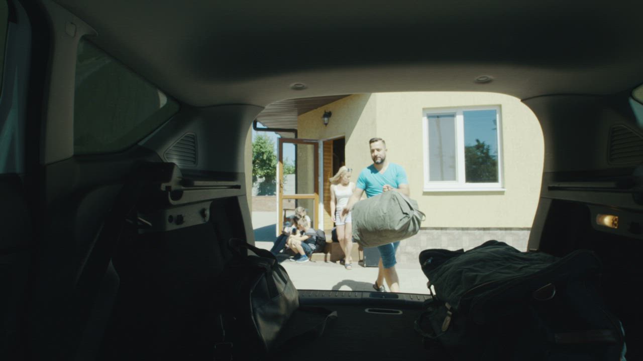 Family packing the bags in the trunk - Free Stock Video
