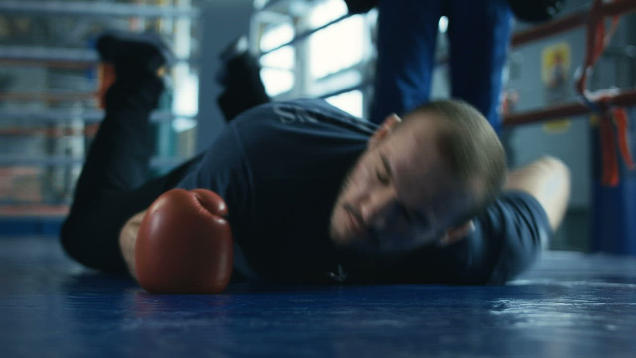 Boxer falling down into the ring floor - Free Stock Video