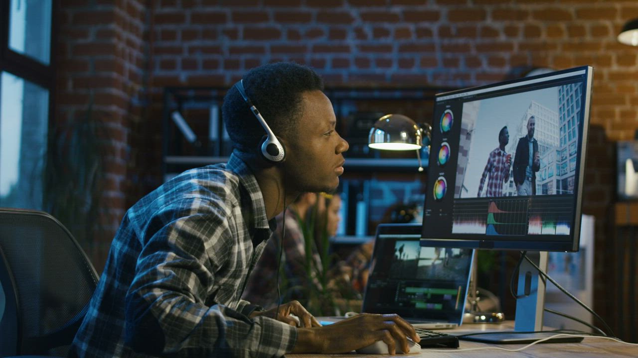 Young man working on video editing at the office - Free Stock Video