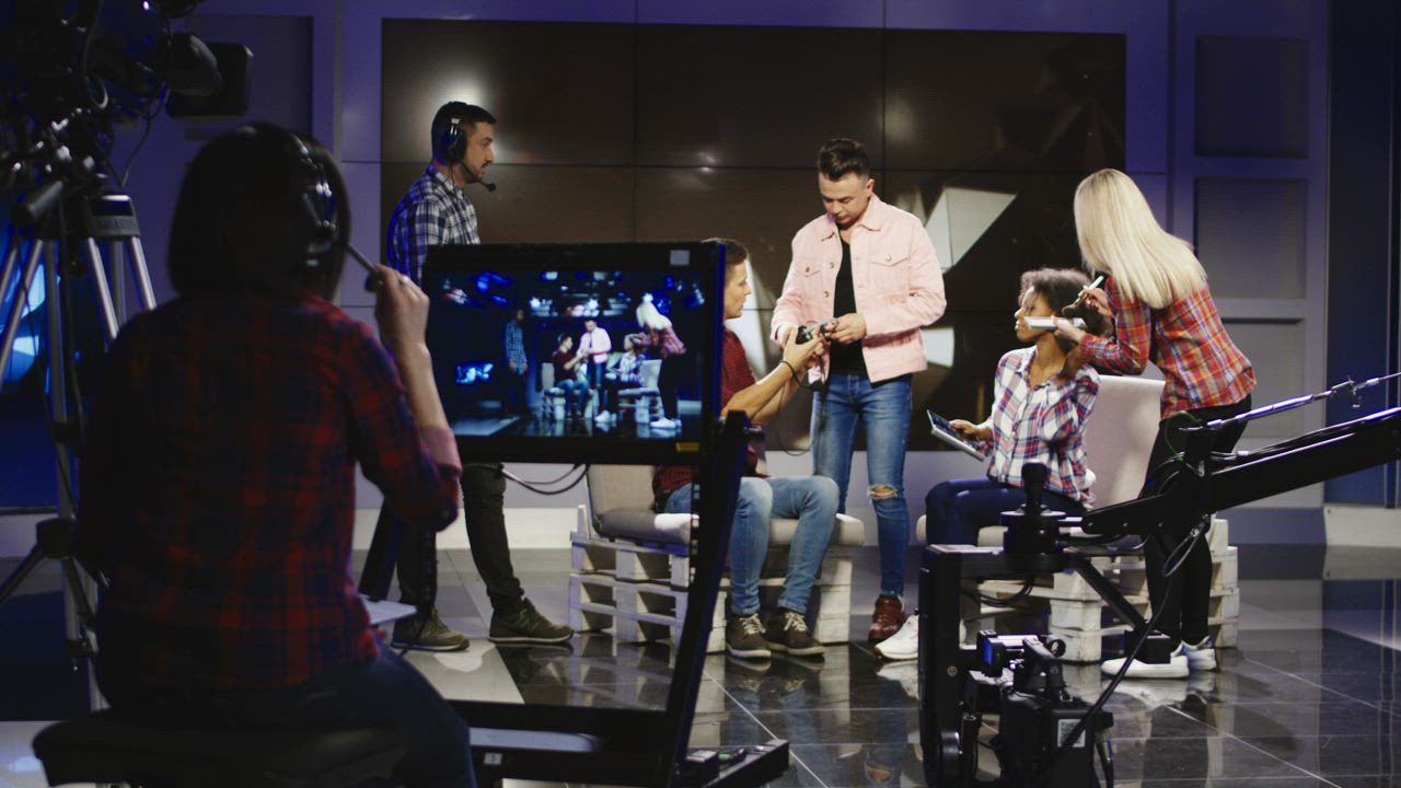 A crew in a television studio getting people ready - Free Stock Video