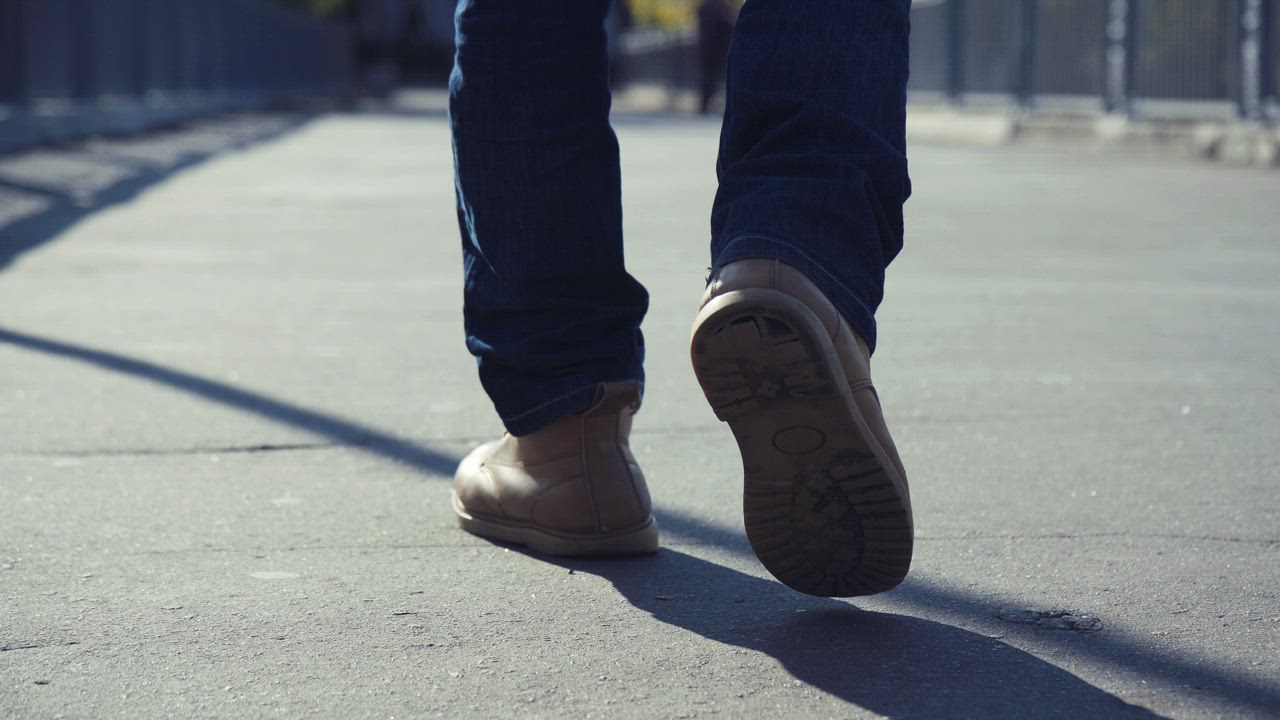 Man walking on the concrete sidewalk - Free Stock Video
