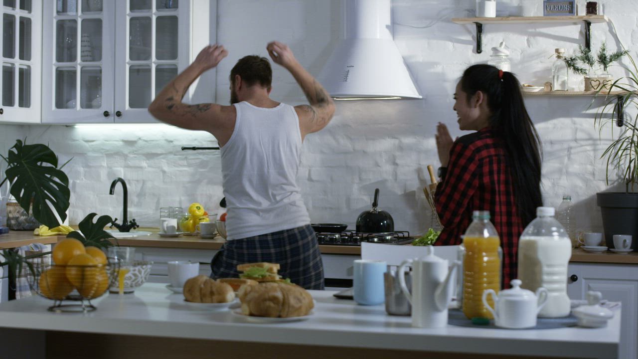 Couple dancing in the kitchen before breakfast - Free Stock Video