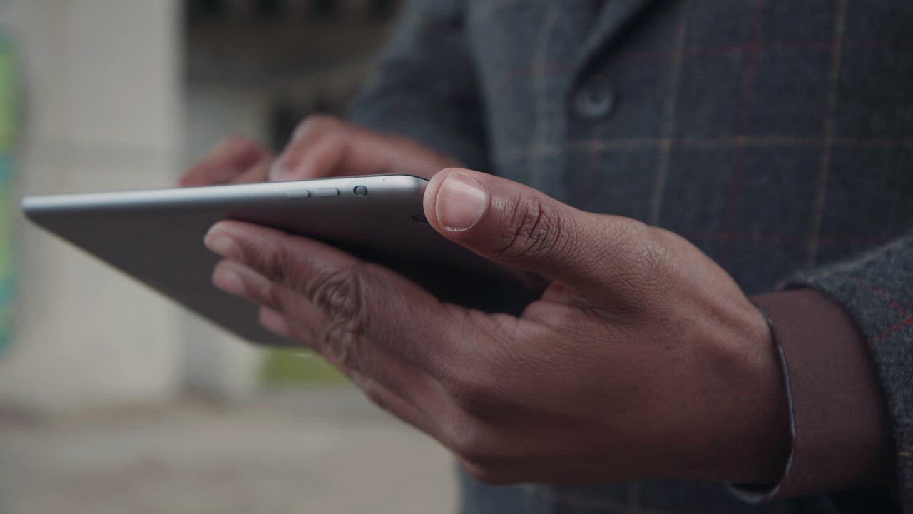 Man in a suit using a tablet - Free Stock Video