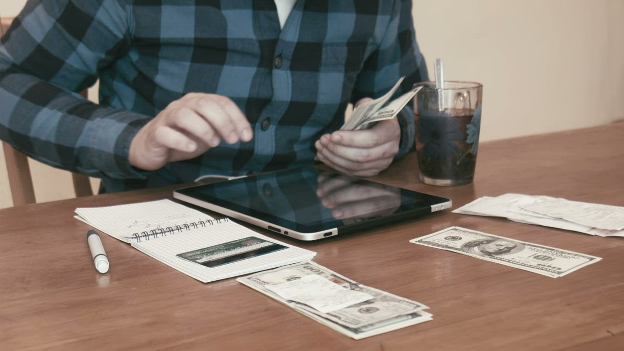 Man separating money for different budgets - Free Stock Video